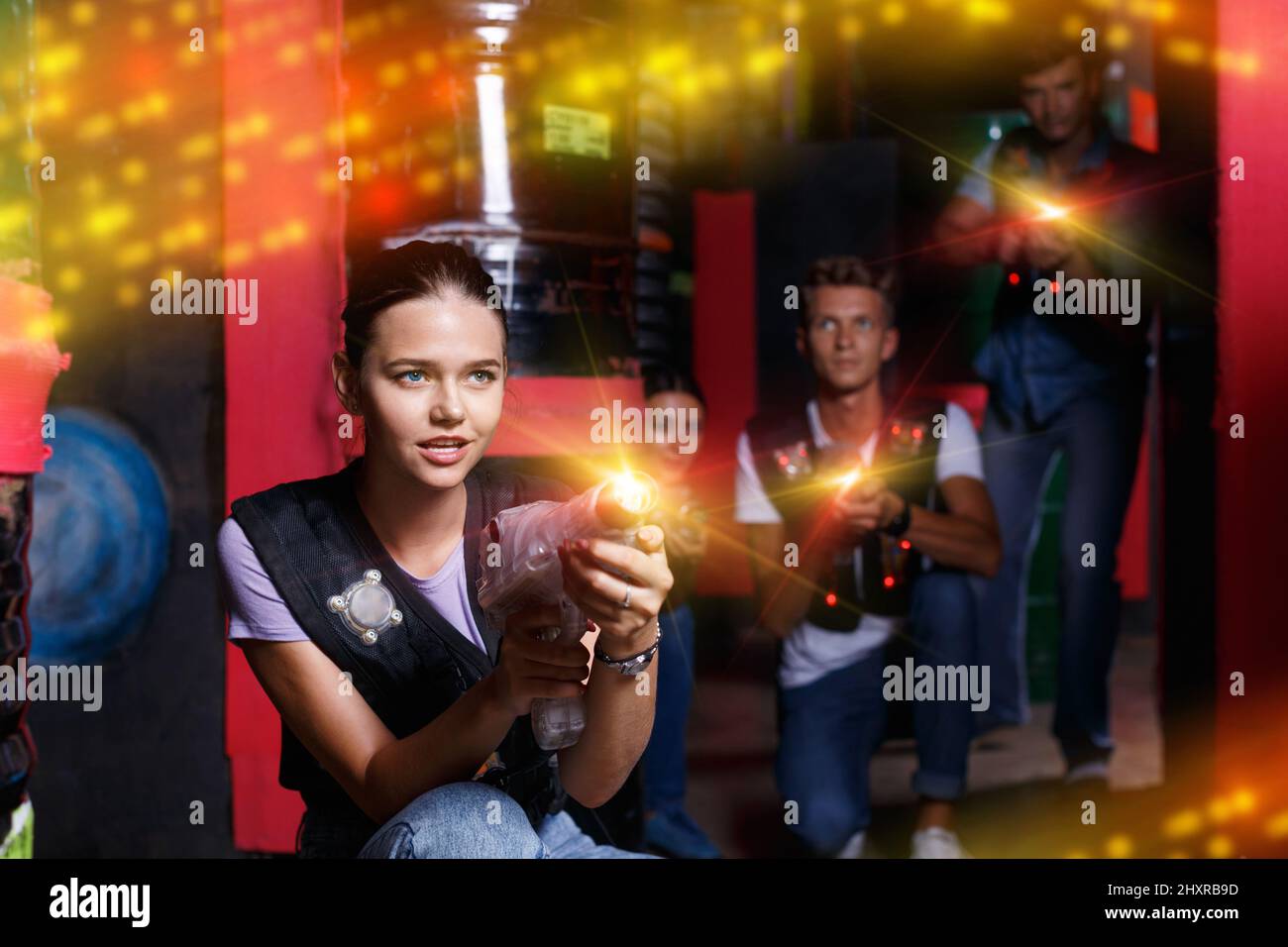 Portrait of young girl took aim colored laser guns during laser Stock ...