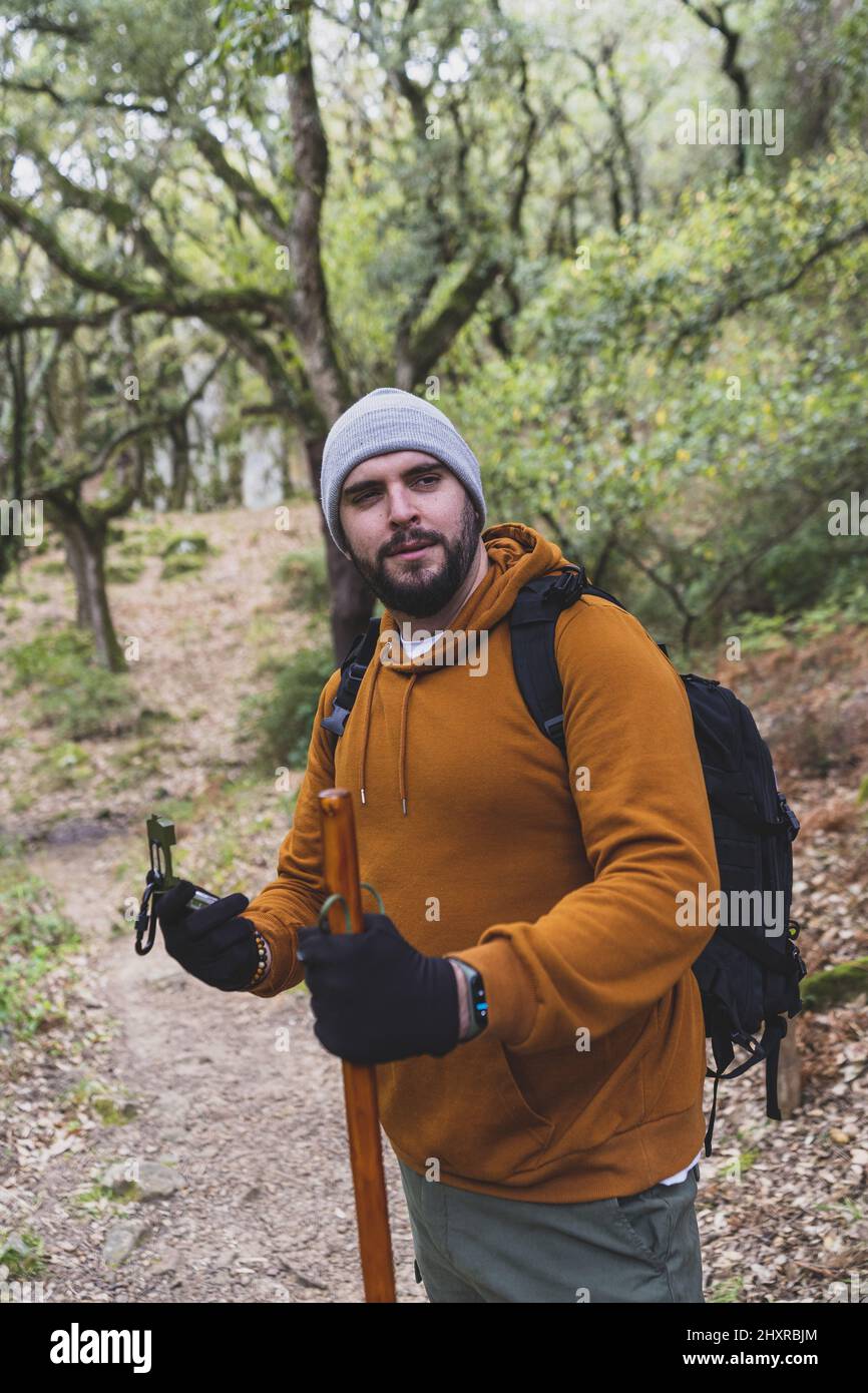 Male holding a compass while hiking in a forest Stock Photo - Alamy