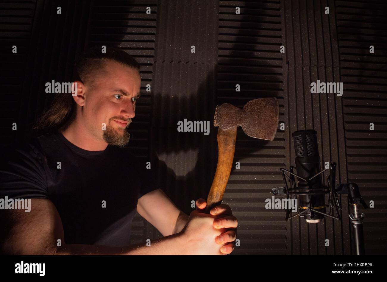 Male with an axe against a microphone Stock Photo - Alamy