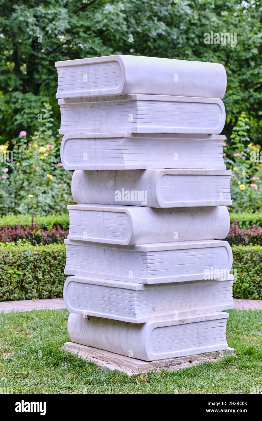 Vertical shot of white marble books sculptures in a park Stock Photo ...