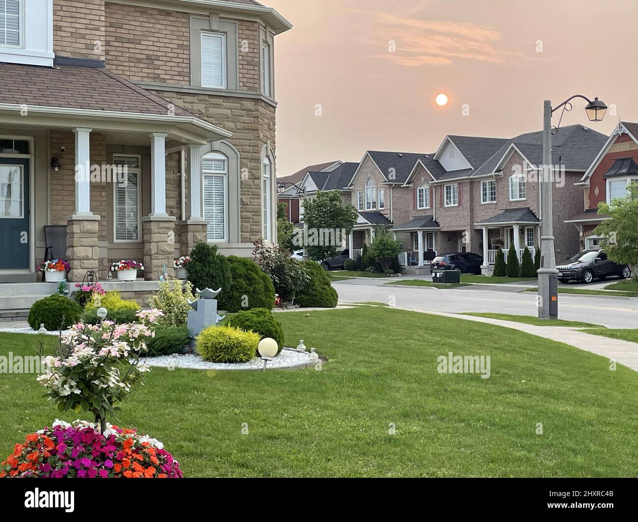View of a rich neighborhood with green lawns and beautiful houses Stock ...