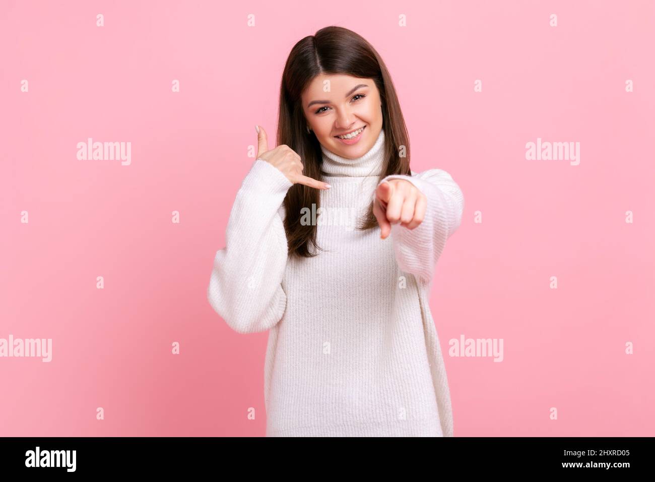 Smiling positive young adult female showing call me gesture with hand ...