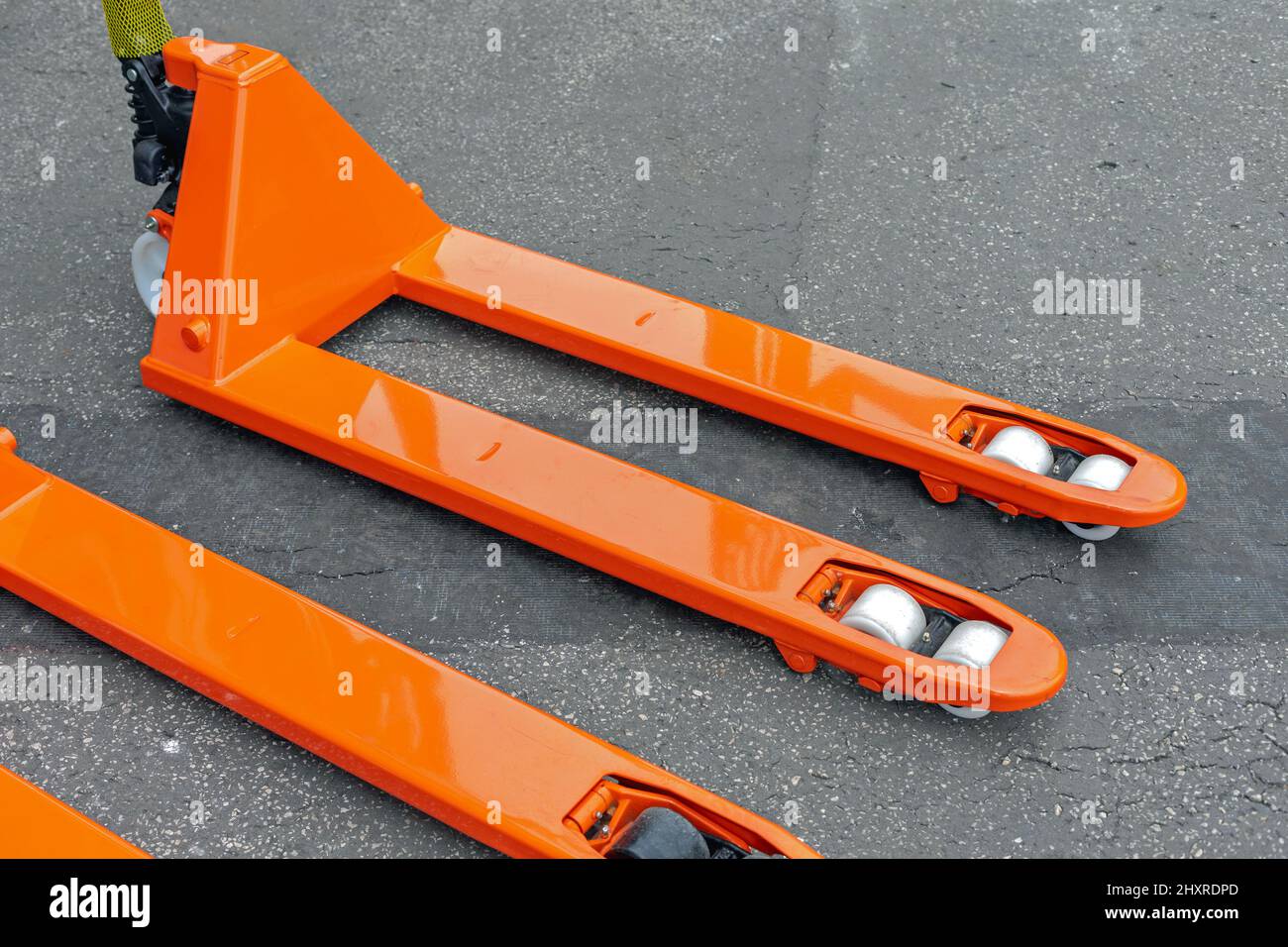 Long Orange Forks With Wheels at Pallet Jack Stock Photo - Alamy