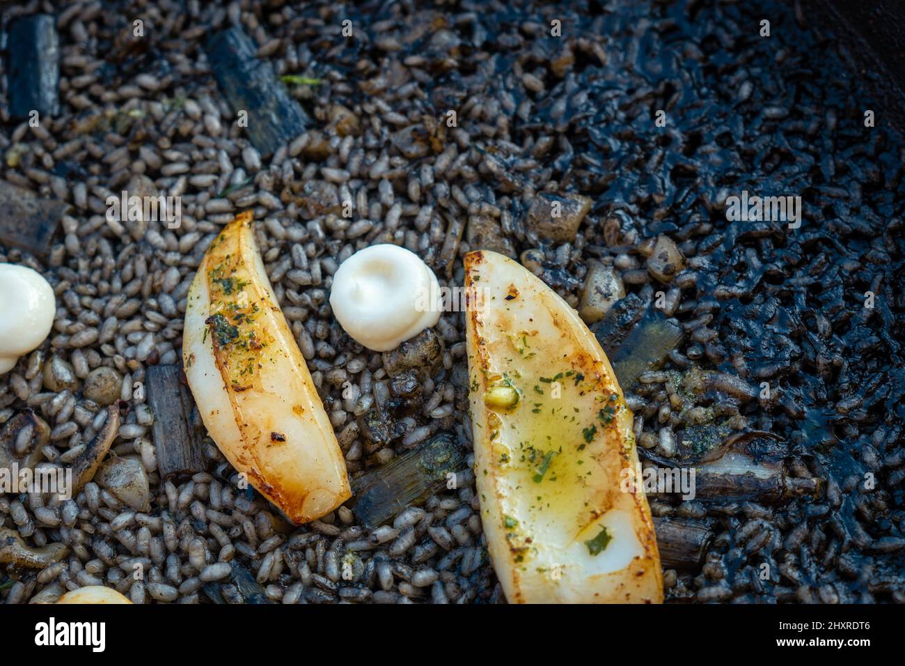 Closeup of Black rice with cuttlefish and young garlic in Spain Stock ...