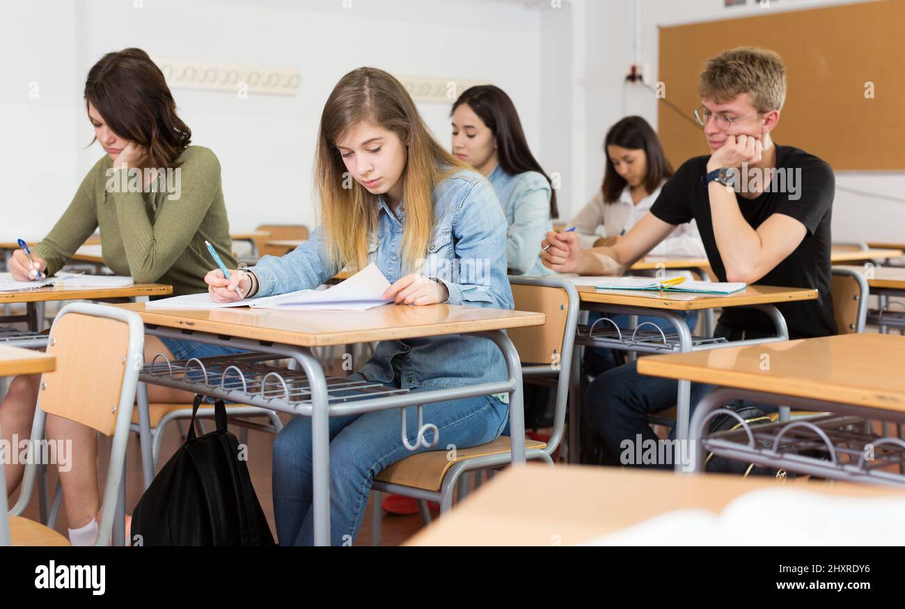 Girl is writing test and answer about task Stock Photo - Alamy