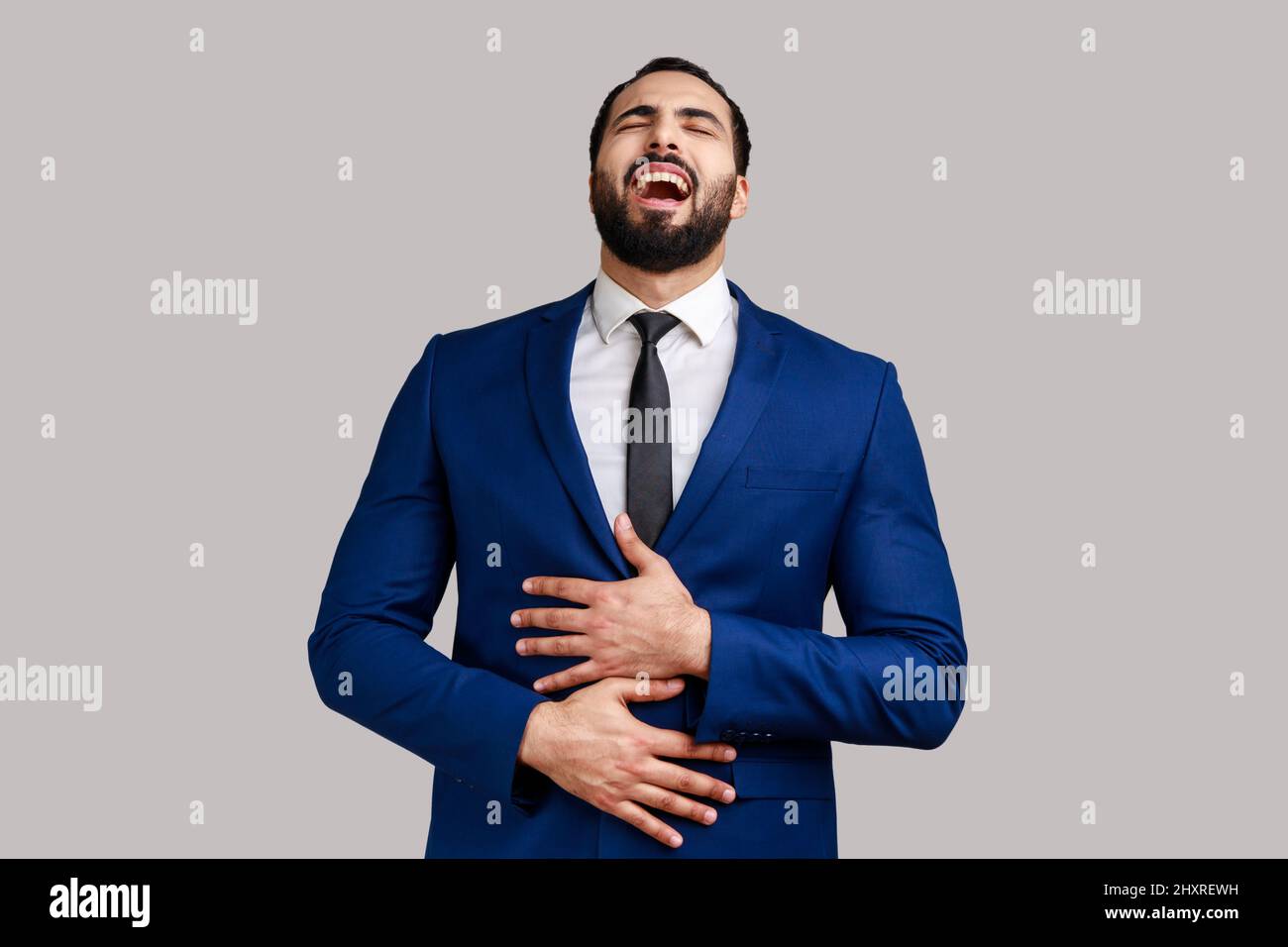 Portrait of positive optimistic bearded man laughing loud, hearing ...