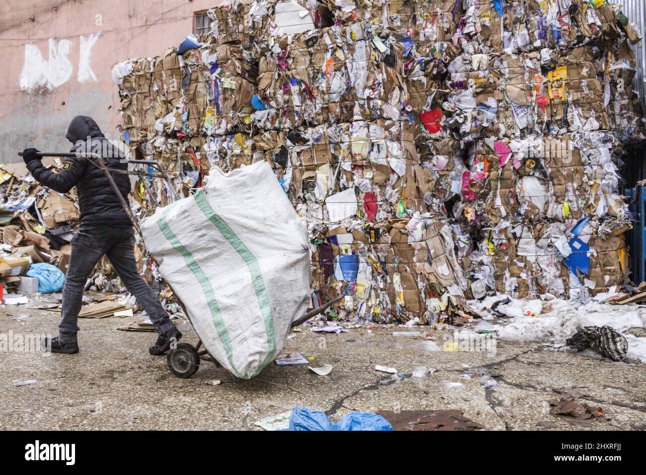 Working man in a black coat restoring garbage in Istanbul Turkey Stock ...