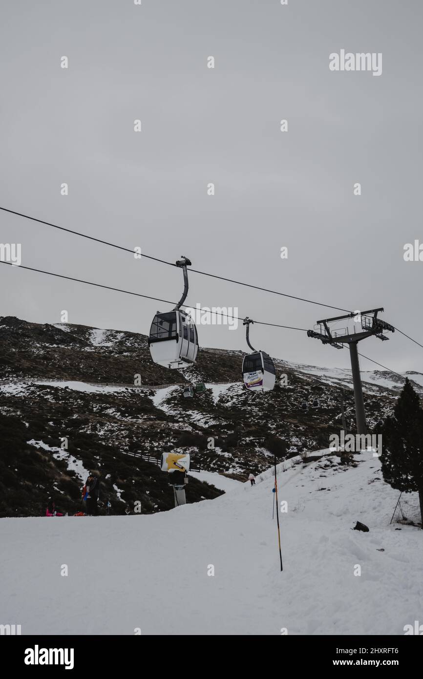 Closeup of Ski Lifts with snowy Mountains Stock Photo - Alamy