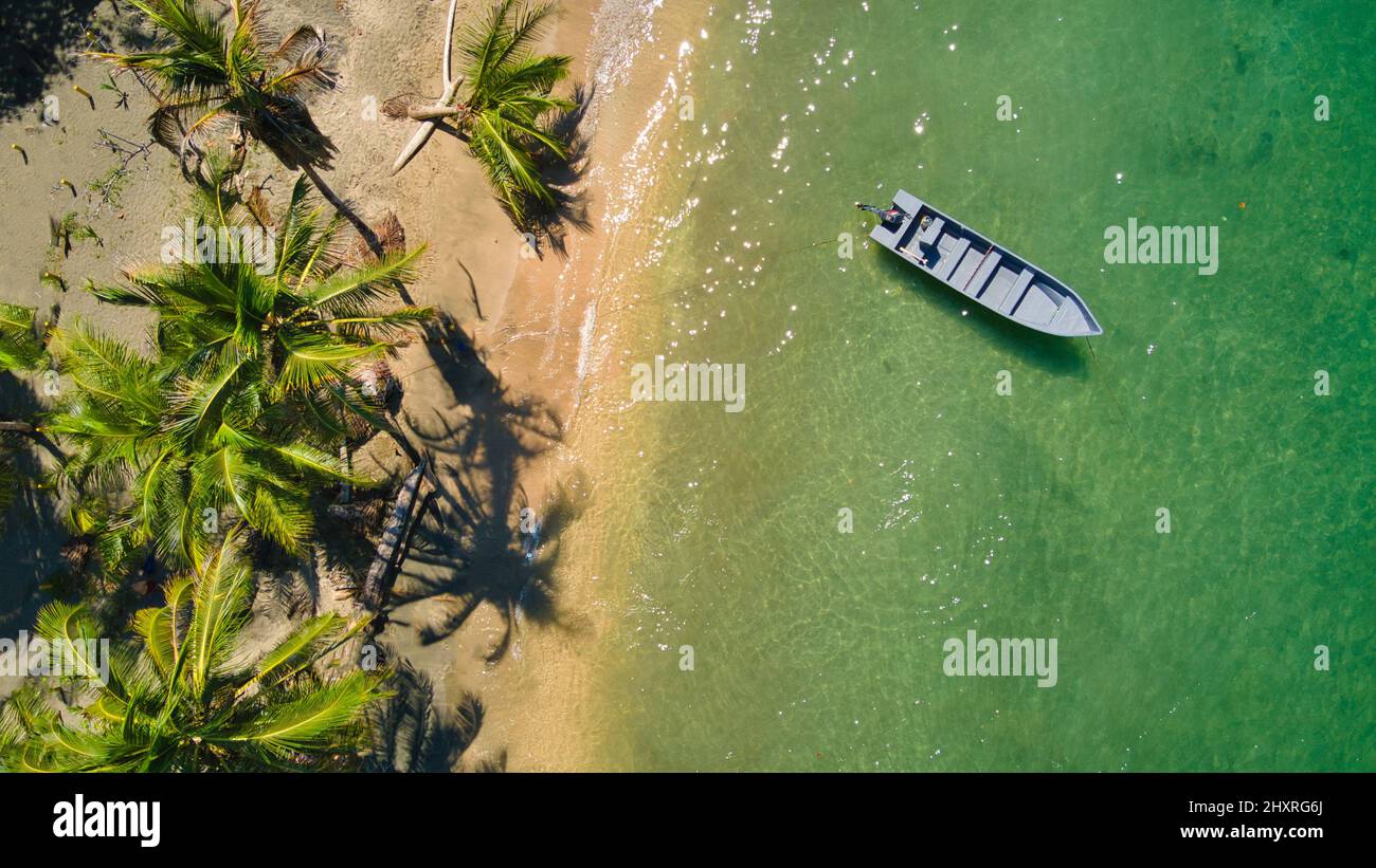 Aerial view of a boat floating near a tropical seashore Stock Photo - Alamy