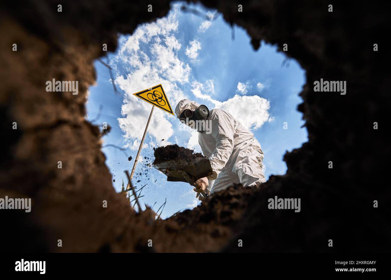 View from inside pit male ecologist digging pit by shovel, wearing ...