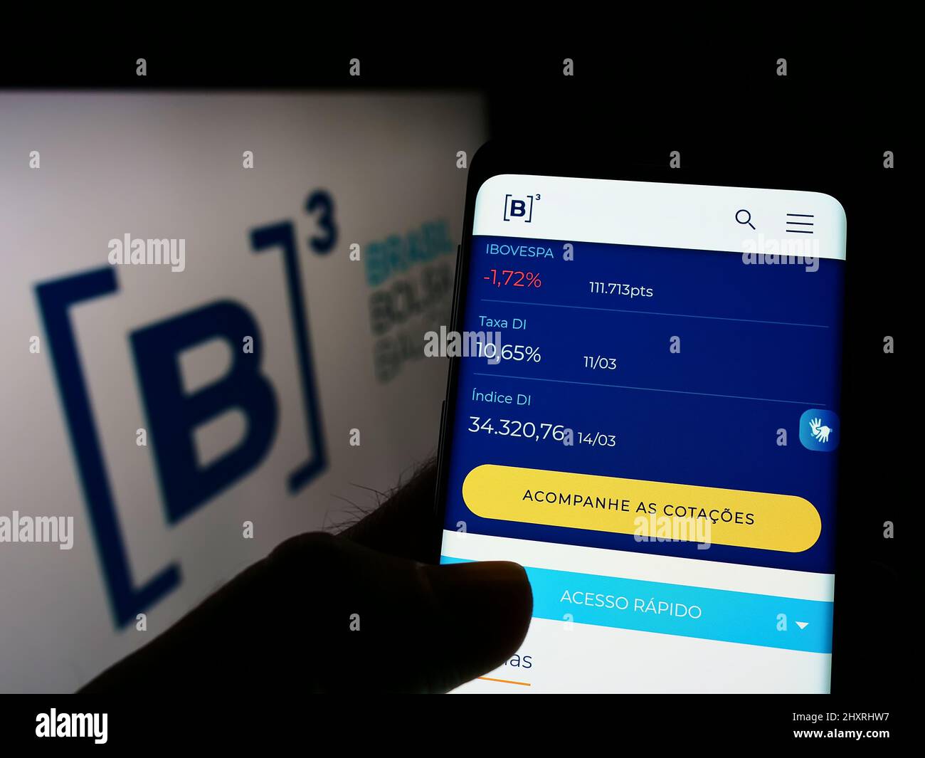 Person holding smartphone with website of company B3 S.A. - Brasil ...