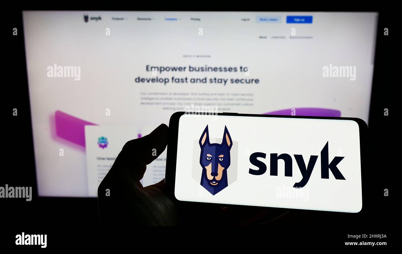 Person holding cellphone with logo of US cybersecurity company Snyk ...