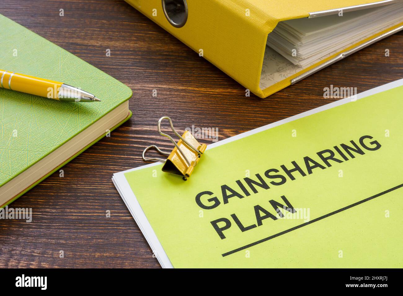 Gainsharing plan papers and a yellow folder Stock Photo - Alamy