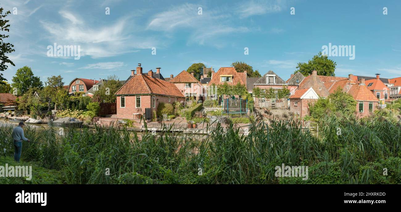 Houses with a garden at the bank of the canal Winsumerdiep, Winsum ...