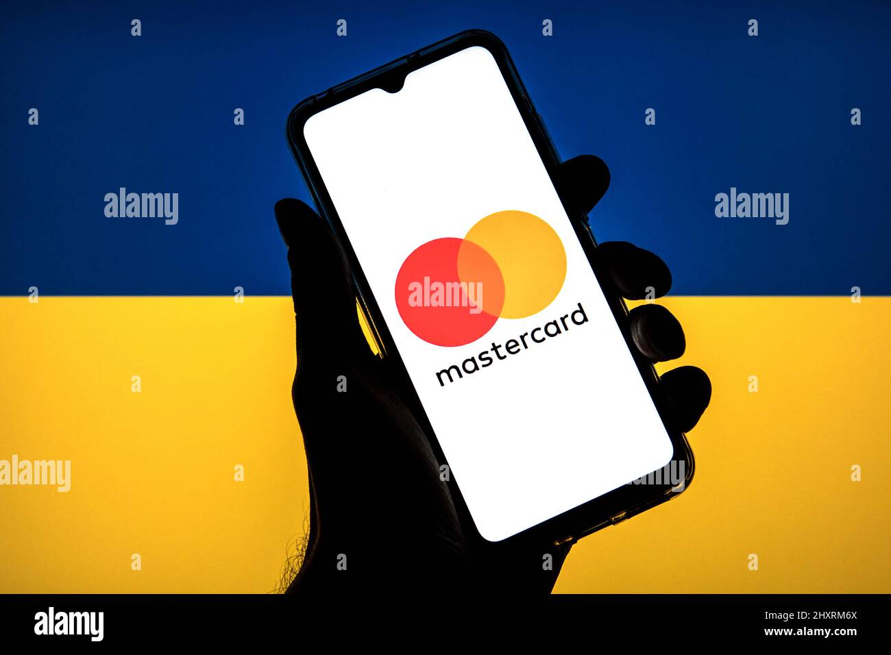 In this photo illustration a Mastercard logo seen displayed on a ...