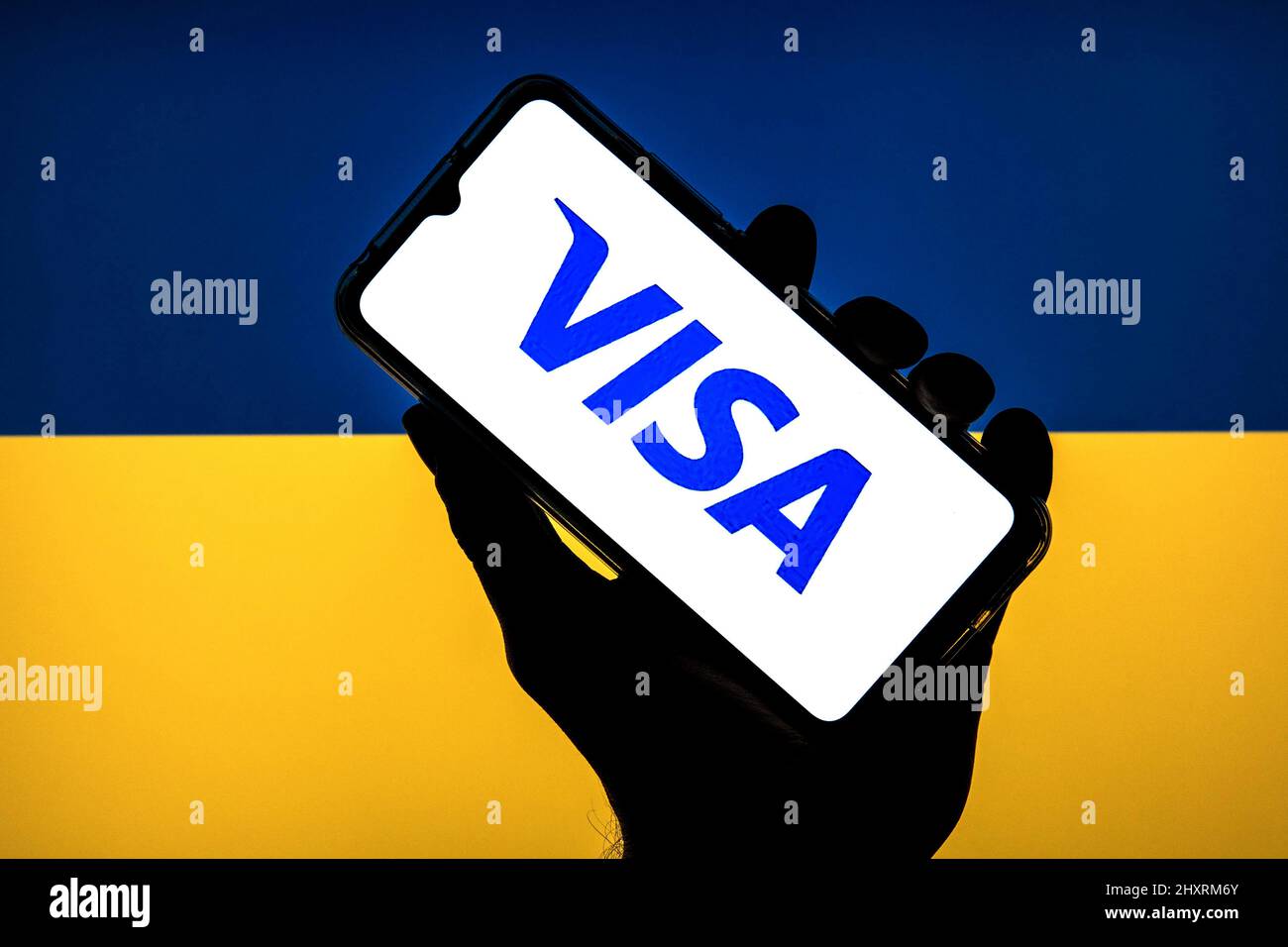 In this photo illustration a Visa logo seen displayed on a smartphone ...