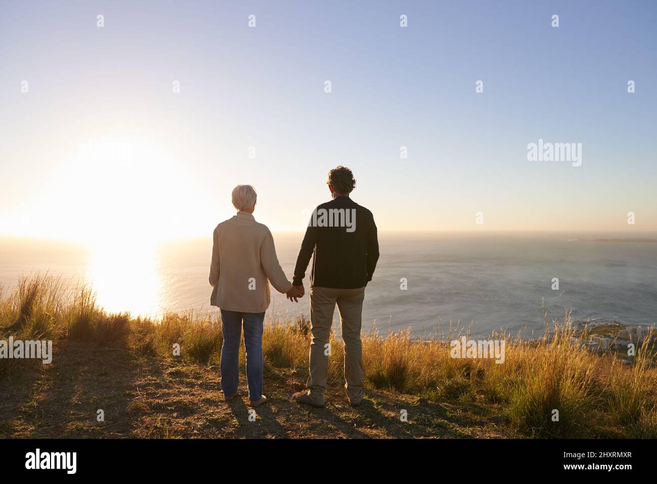 Facing life together. View of a senior couple standing on a hillside ...