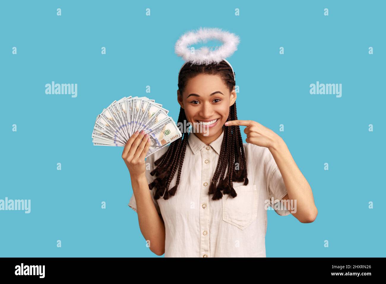 Portrait of smiling angelic woman with dreadlocks and nimb over head ...