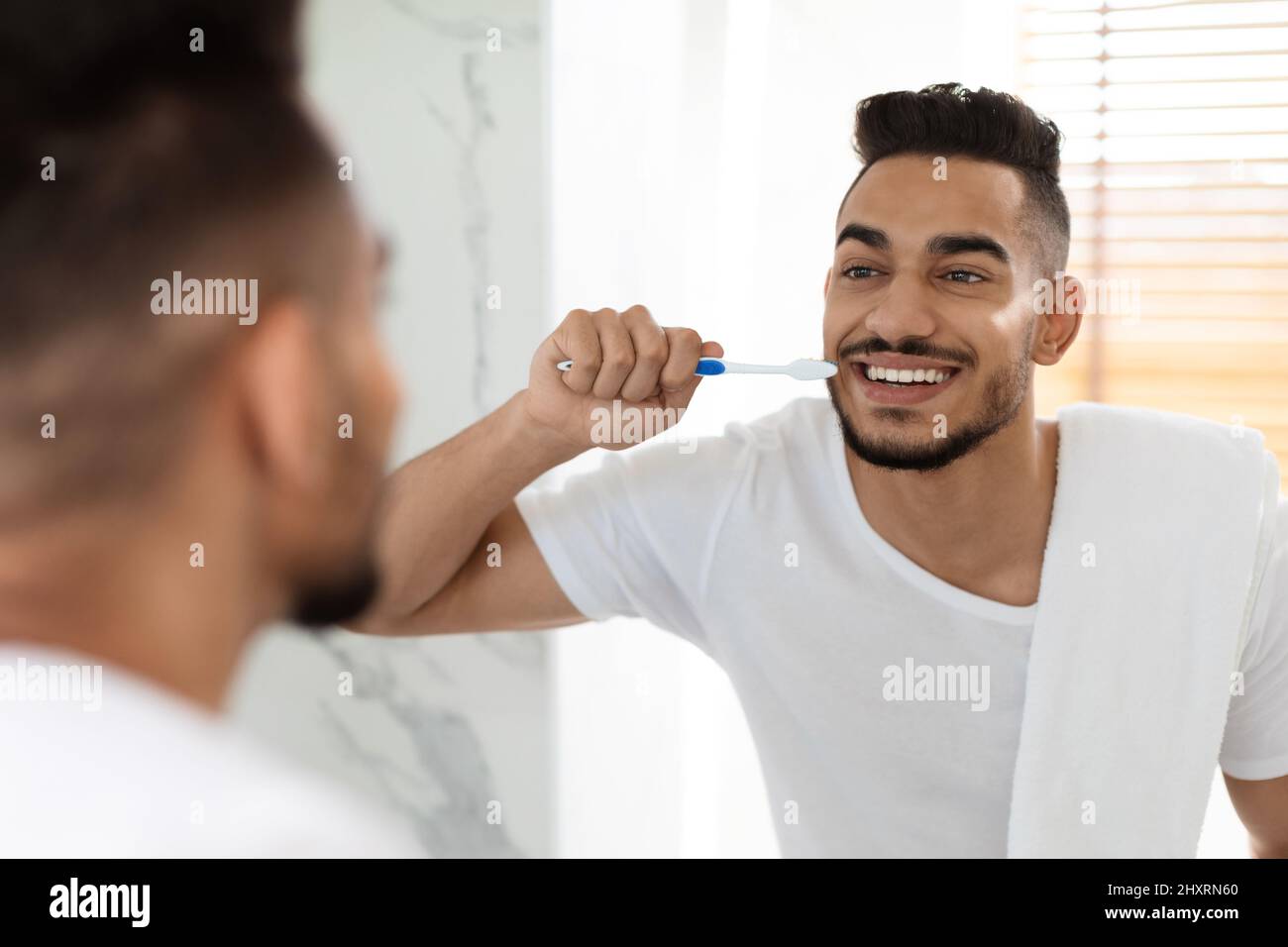 Handsome Millennial Arab Guy Brushing His Teeth With Toothbrush In ...