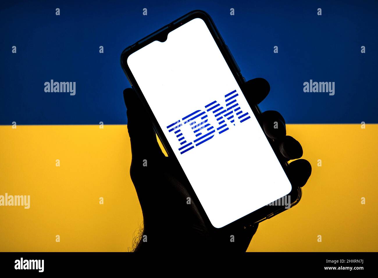 In this photo illustration a IBM logo seen displayed on a smartphone ...