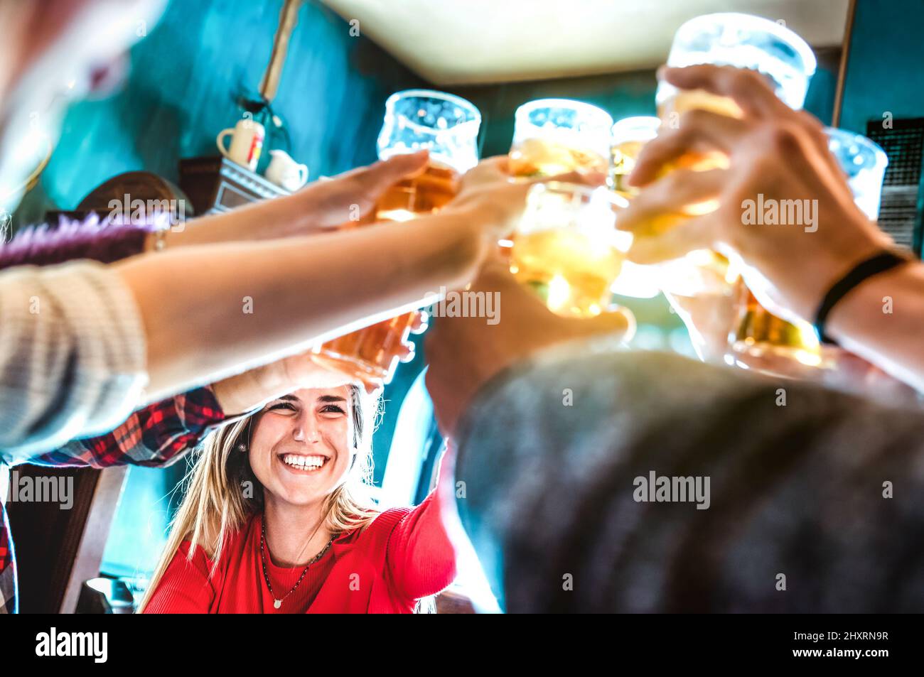 Friends drinking and toasting beer at brewery bar restaurant ...