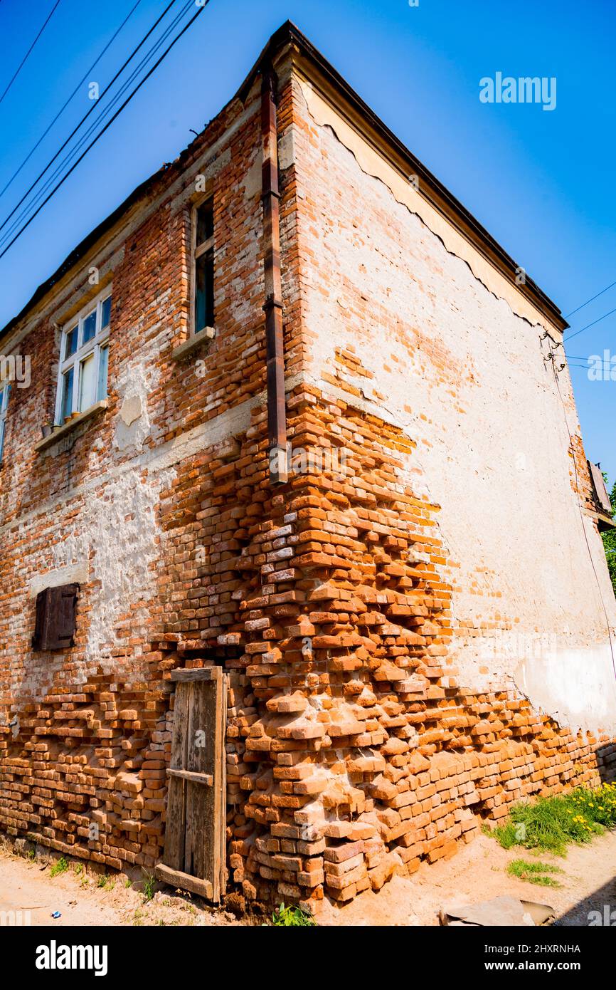 Vertical shot of the facade of aged building with old brick walls on a ...