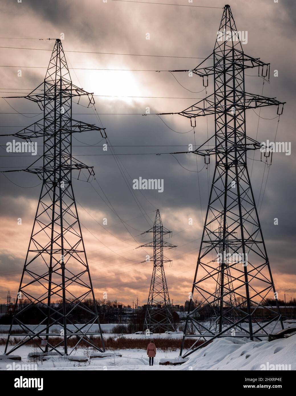 Photo of the girl standing under the power line Stock Photo - Alamy