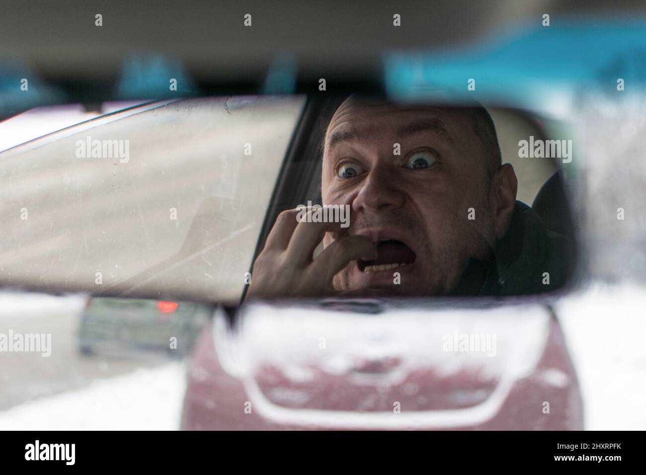 Shocked car driver. Reflection in the rearview mirror Stock Photo - Alamy