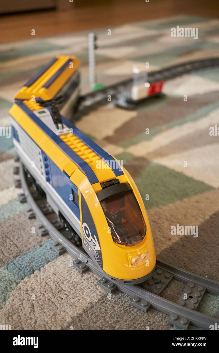 Plastic Lego brand electric toy train and track on a carpet floor Stock ...