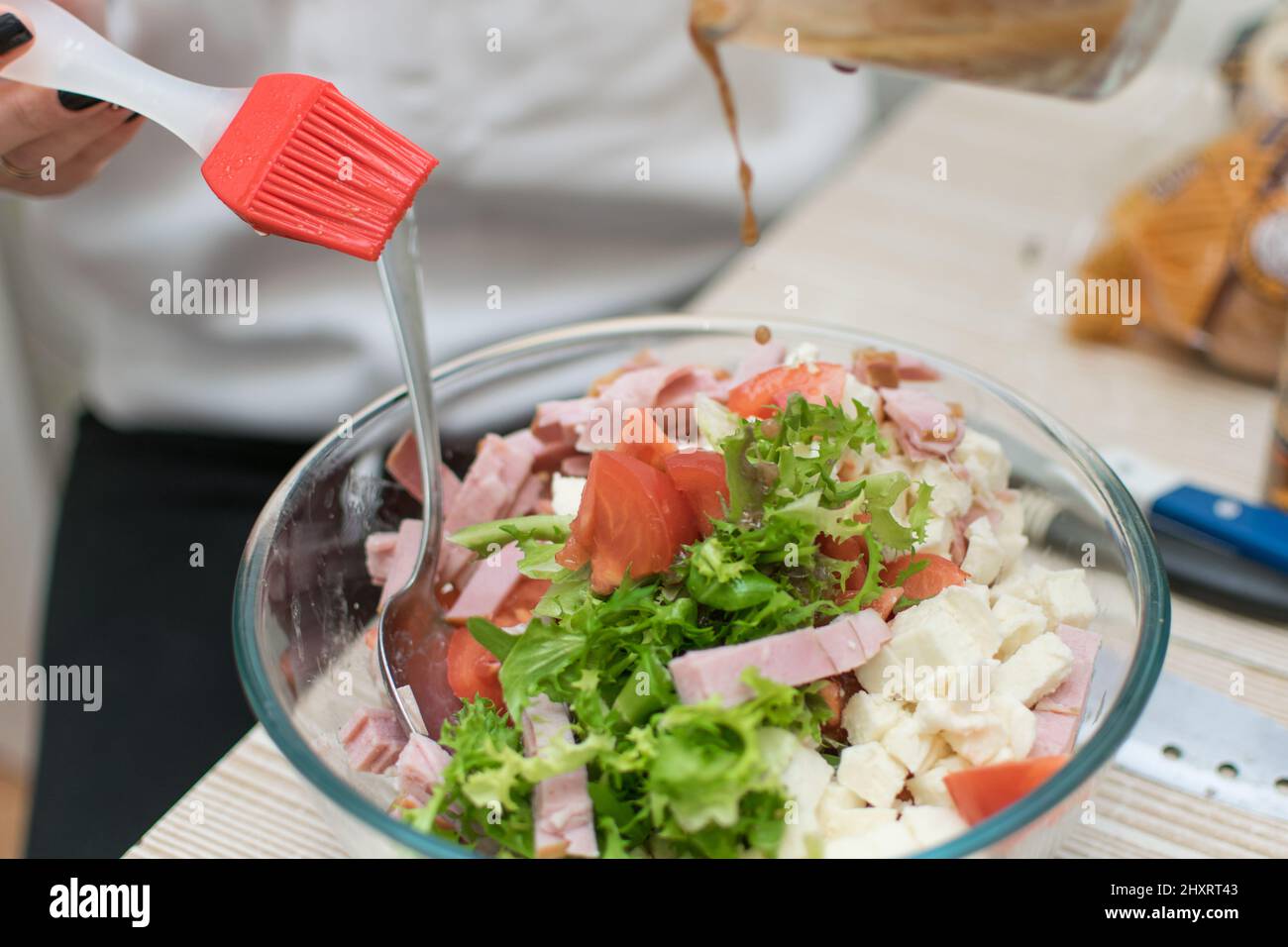 Fresh vegetable salad add sauce Stock Photo - Alamy
