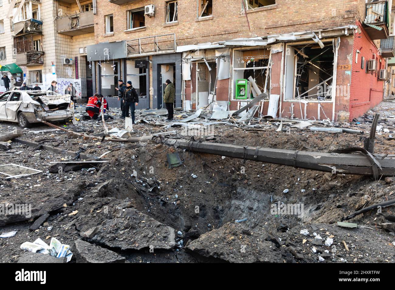 A missile crater in front of civilian houses, following a Russian ...
