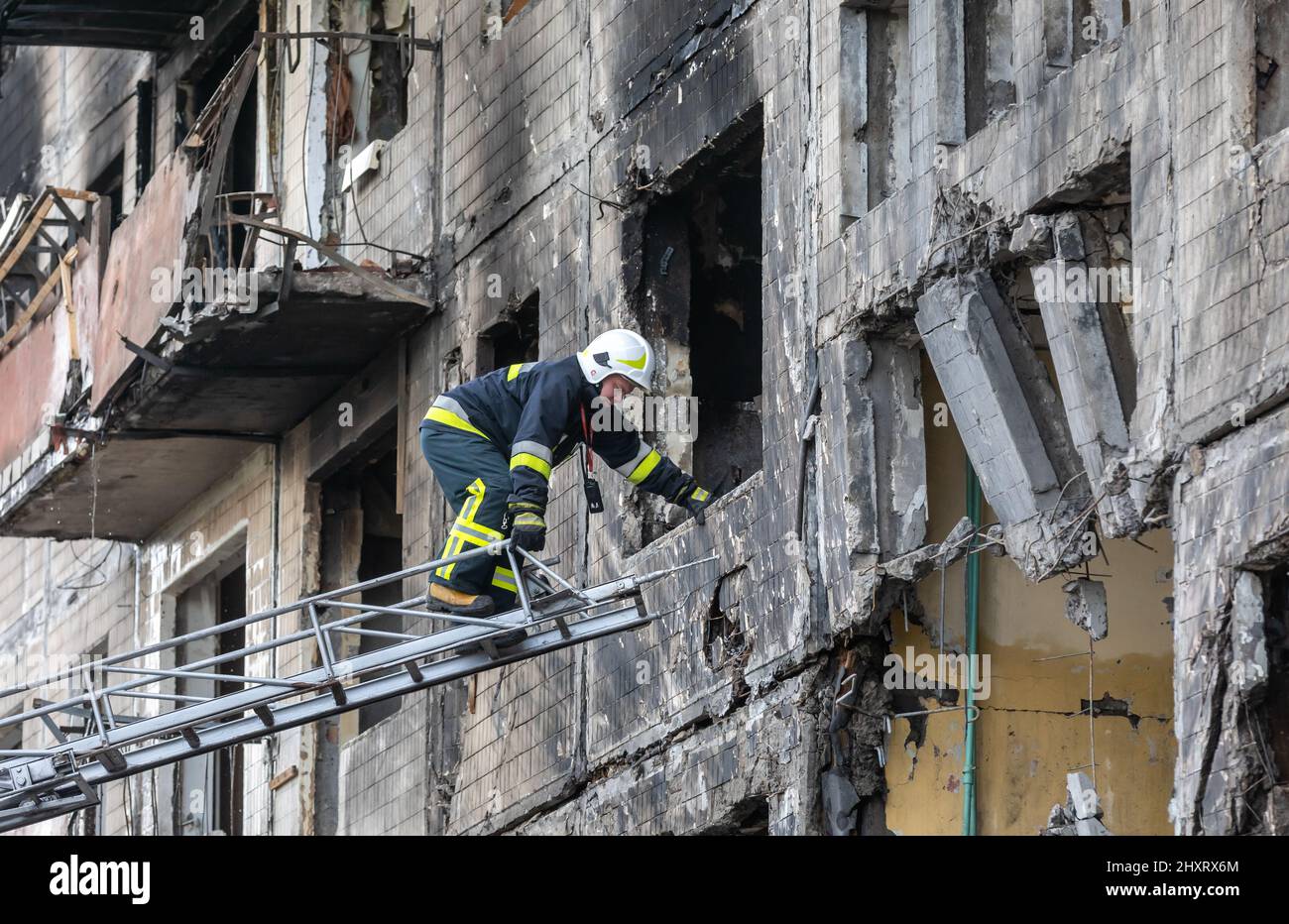 A firefighter seen of a badly damaged residential building that was hit ...