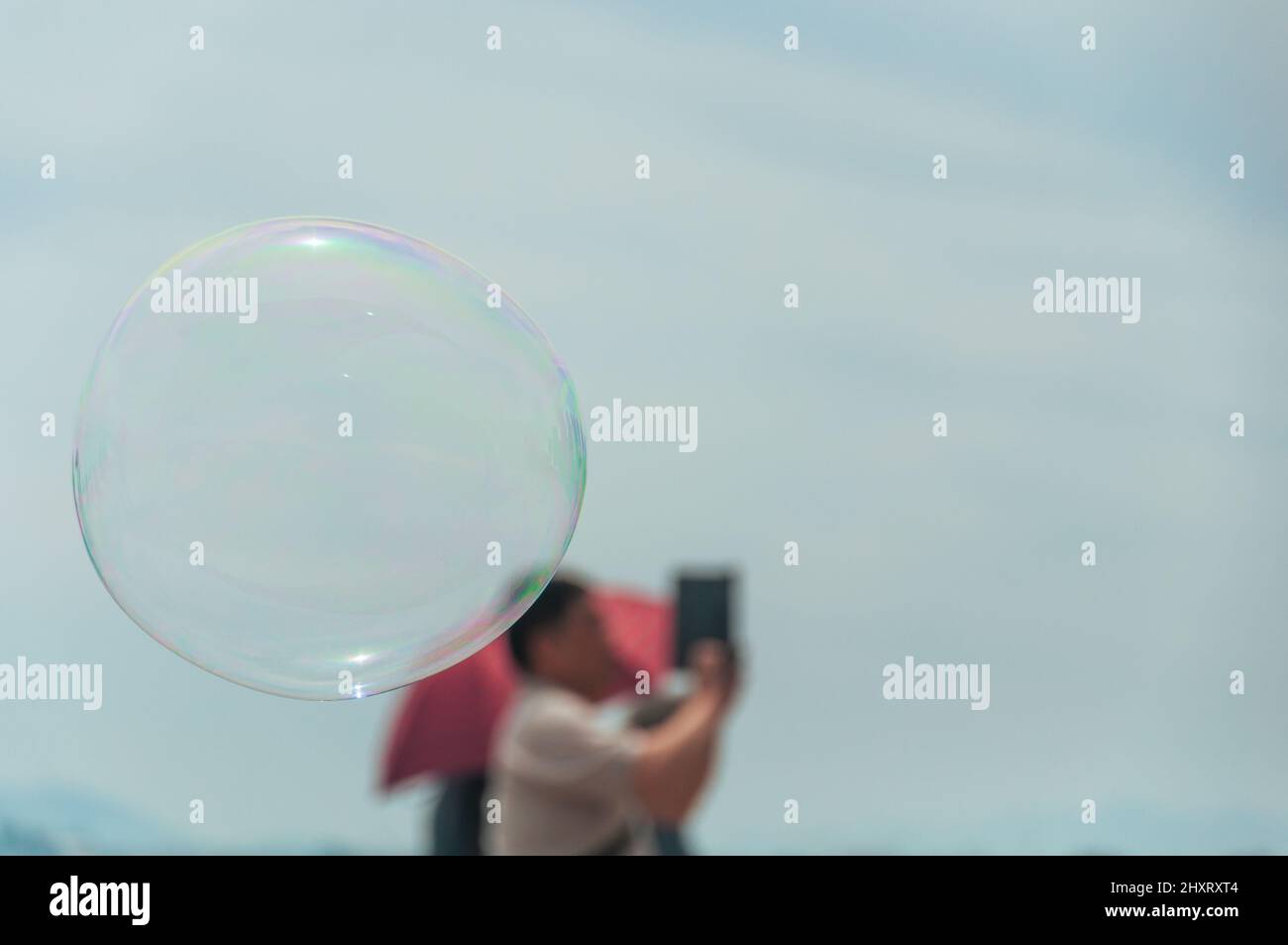 Closeup of a soap bubble floating in the air against the background of ...