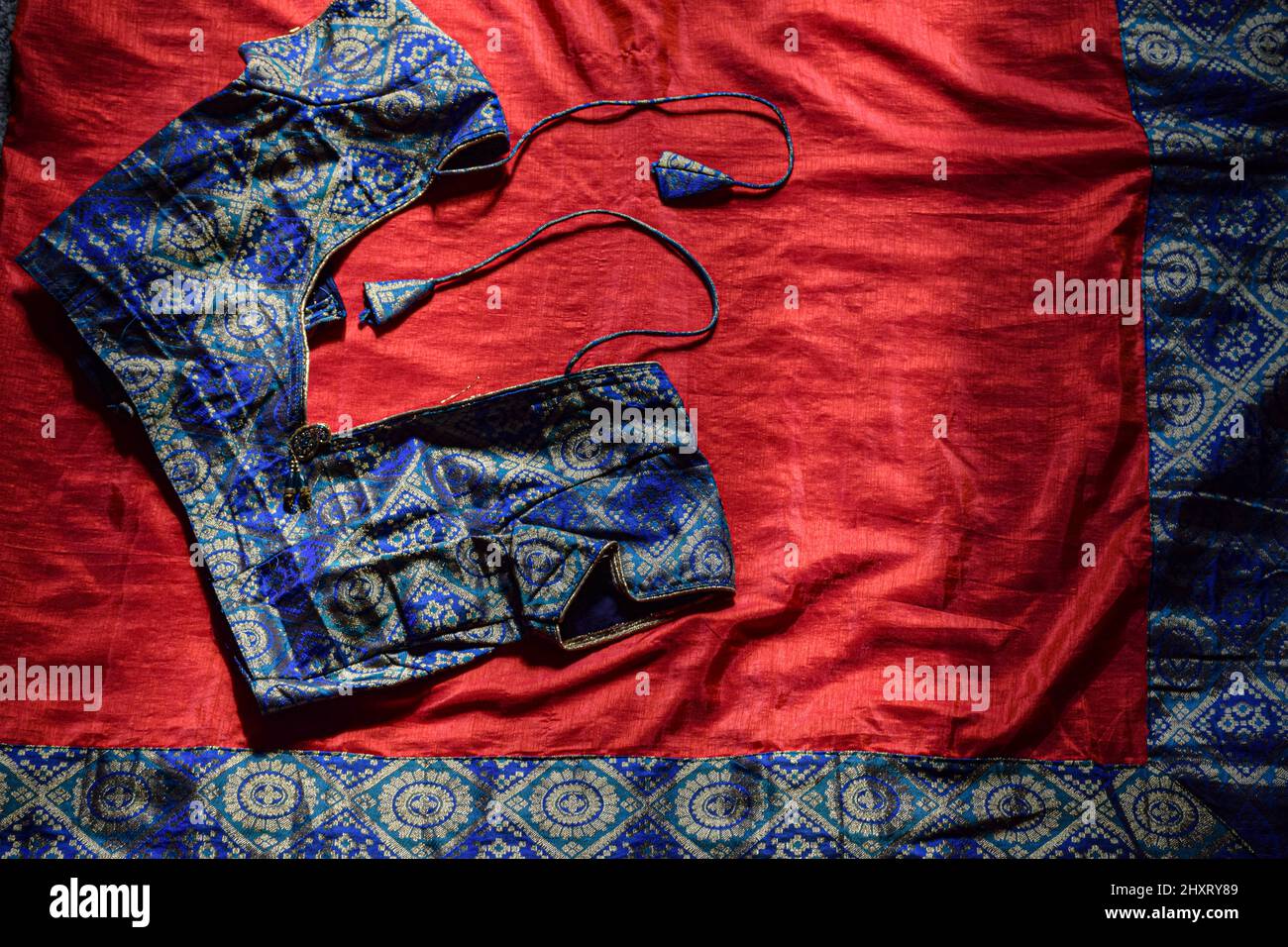 Beautiful red color silk saree with blue and golden color blouse in ...