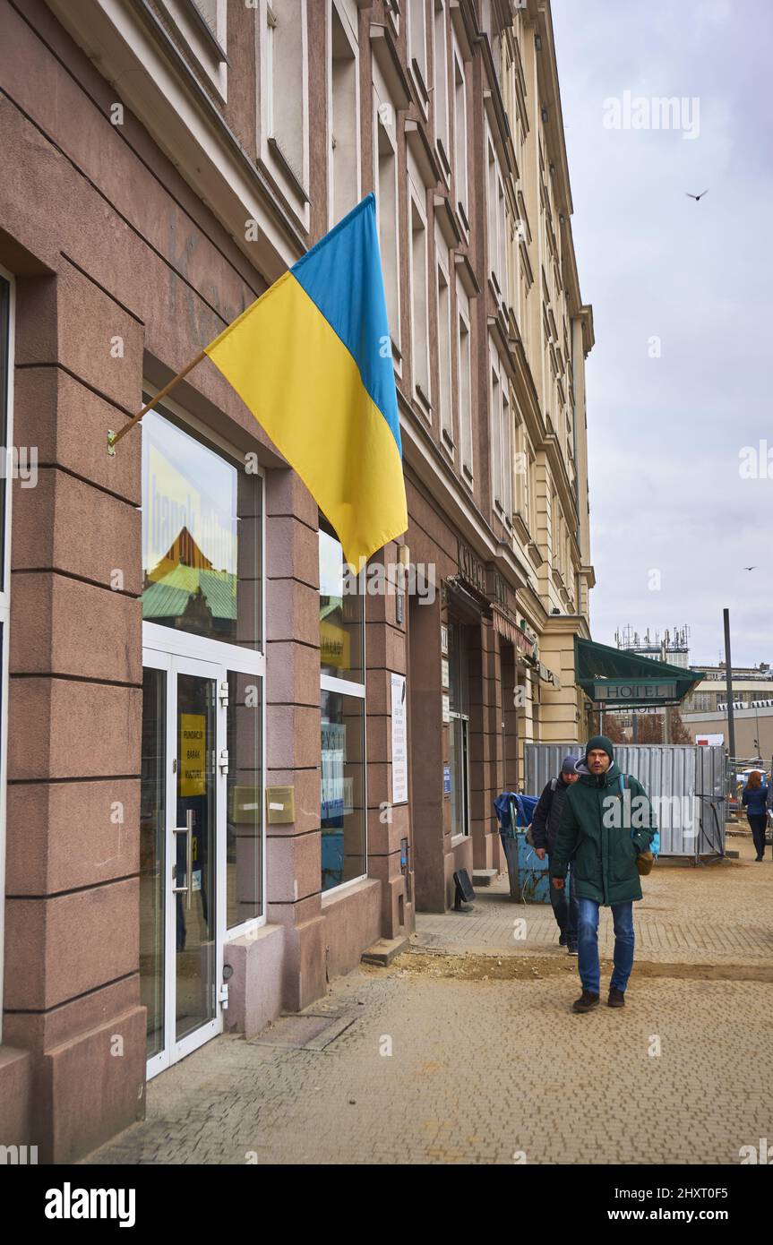 Vertical shot of the Ukrainian national flag in front of a small shop ...