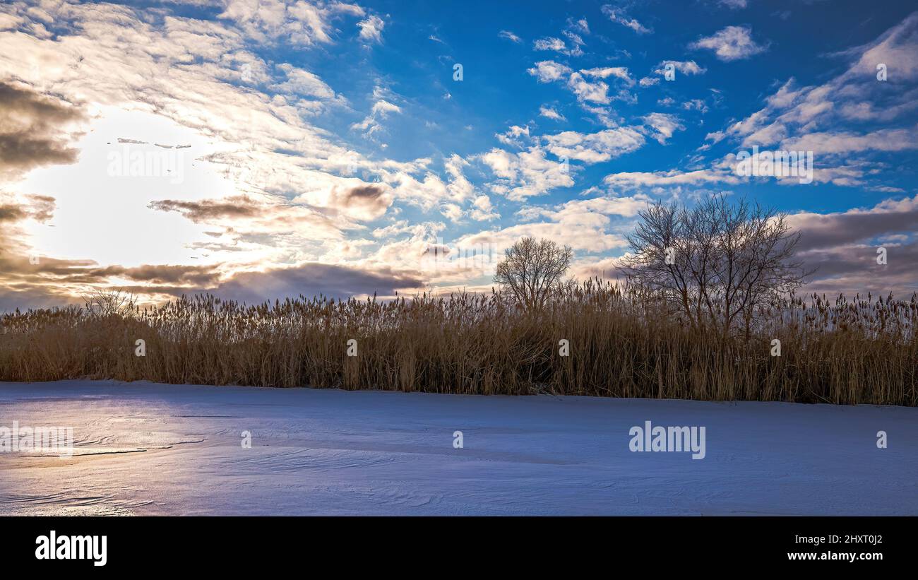At the dusk hours a beautiful set of clouds at a frozen shore Stock ...