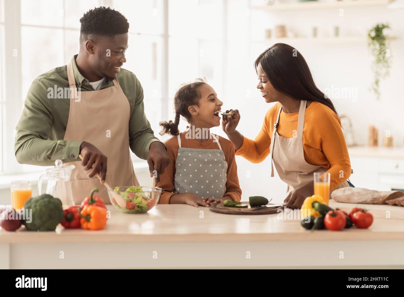 African Family Cooking Having Fun Feeding Each Other In Kitchen Stock ...