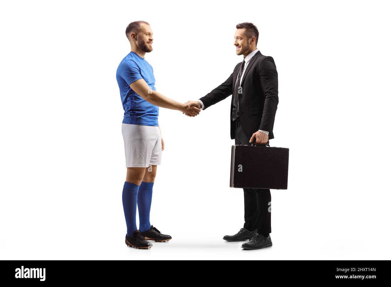 Football player and a businessman shaking hands isolated on white ...