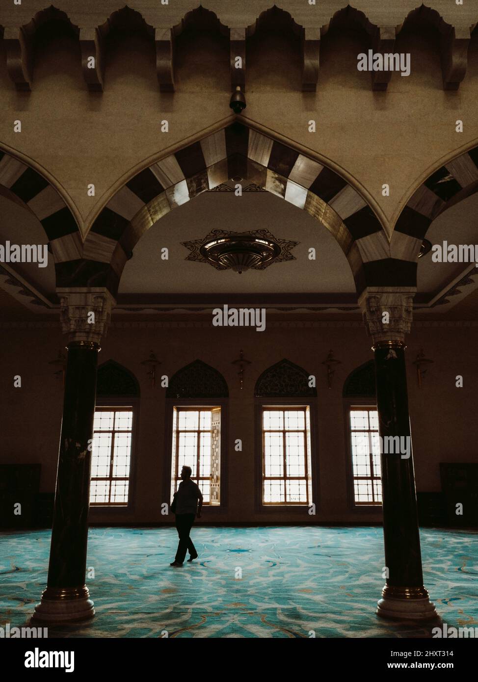 Interior of the mosque with arched columns and colorful carpet Stock ...