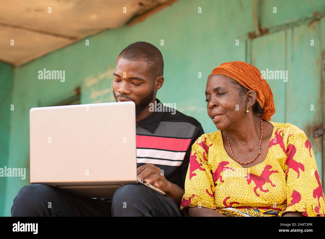 Young black male teaching his older mother how to use technology Stock ...