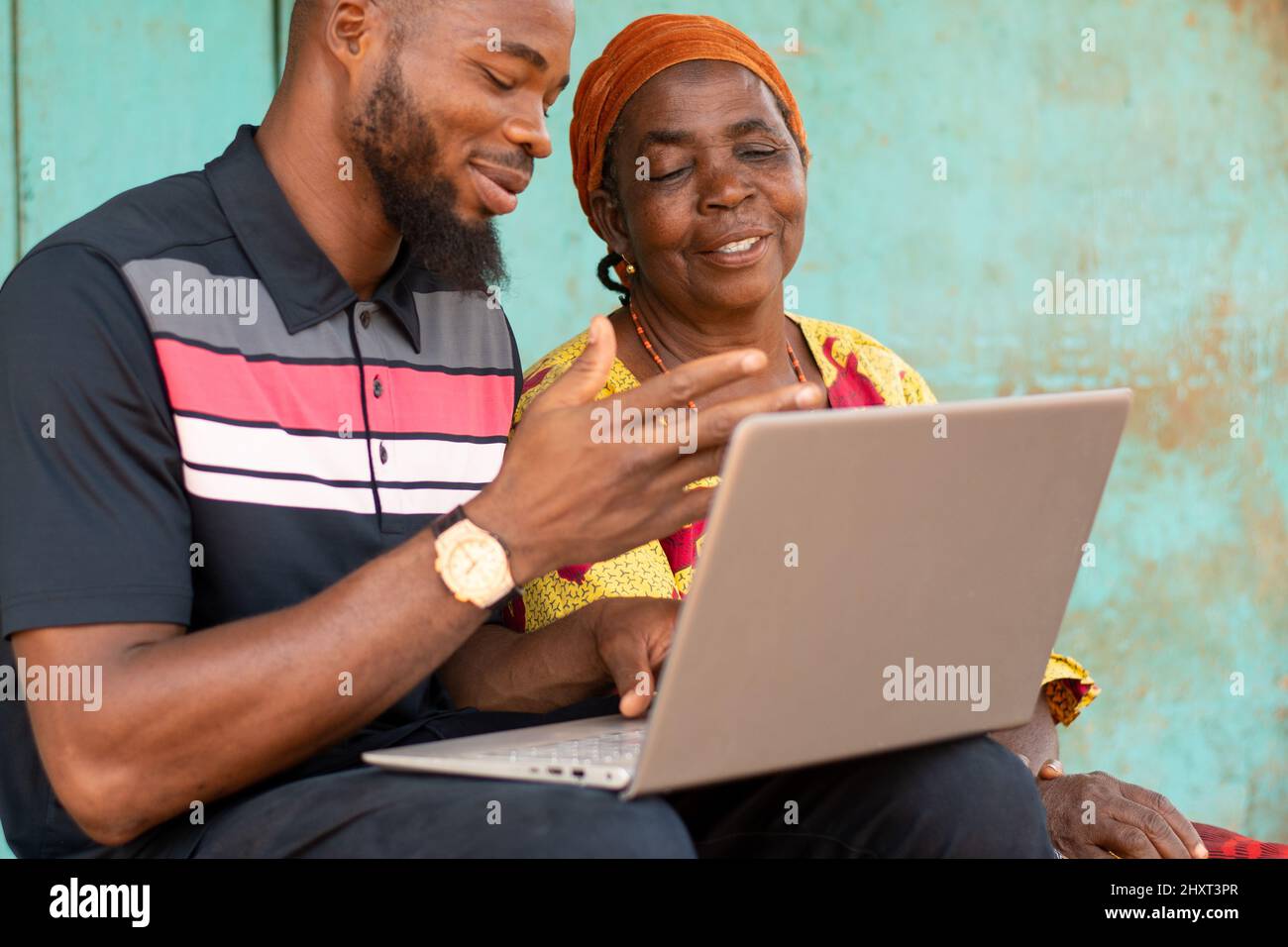 Young black male teaching his older mother how to use technology Stock ...