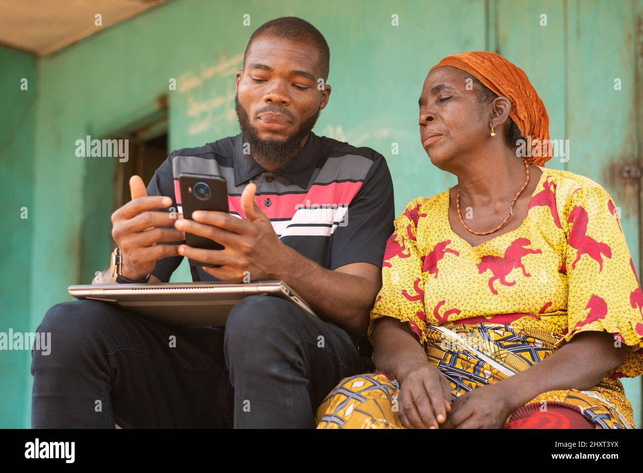 Young black male teaching his older mother how to use technology Stock ...