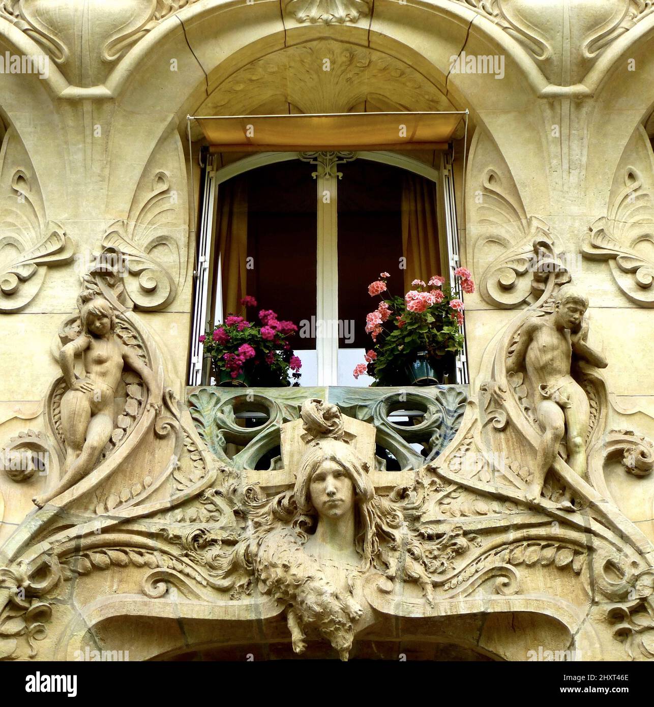 View of a window and a window box with geraniums in a building with ...