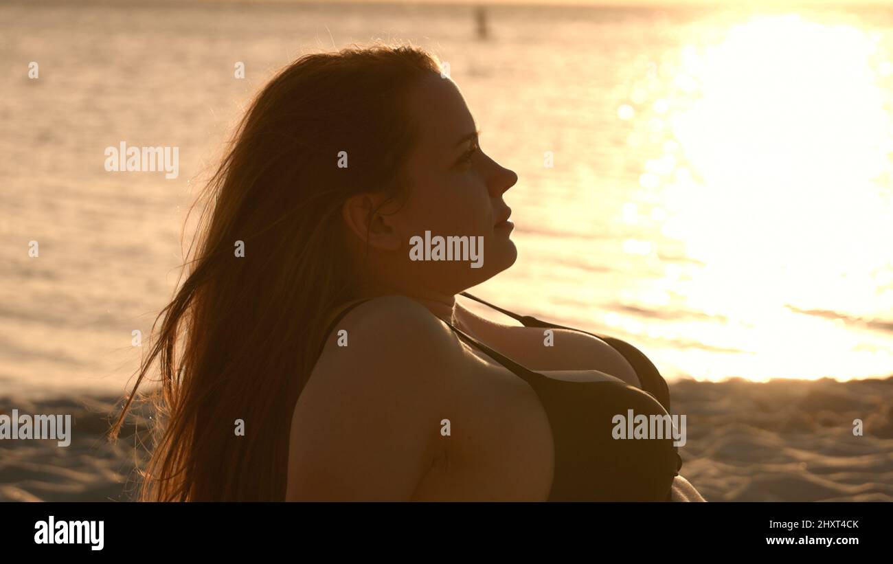 Relaxing at the beach on sunset enjoying the warm sun rays over the ...