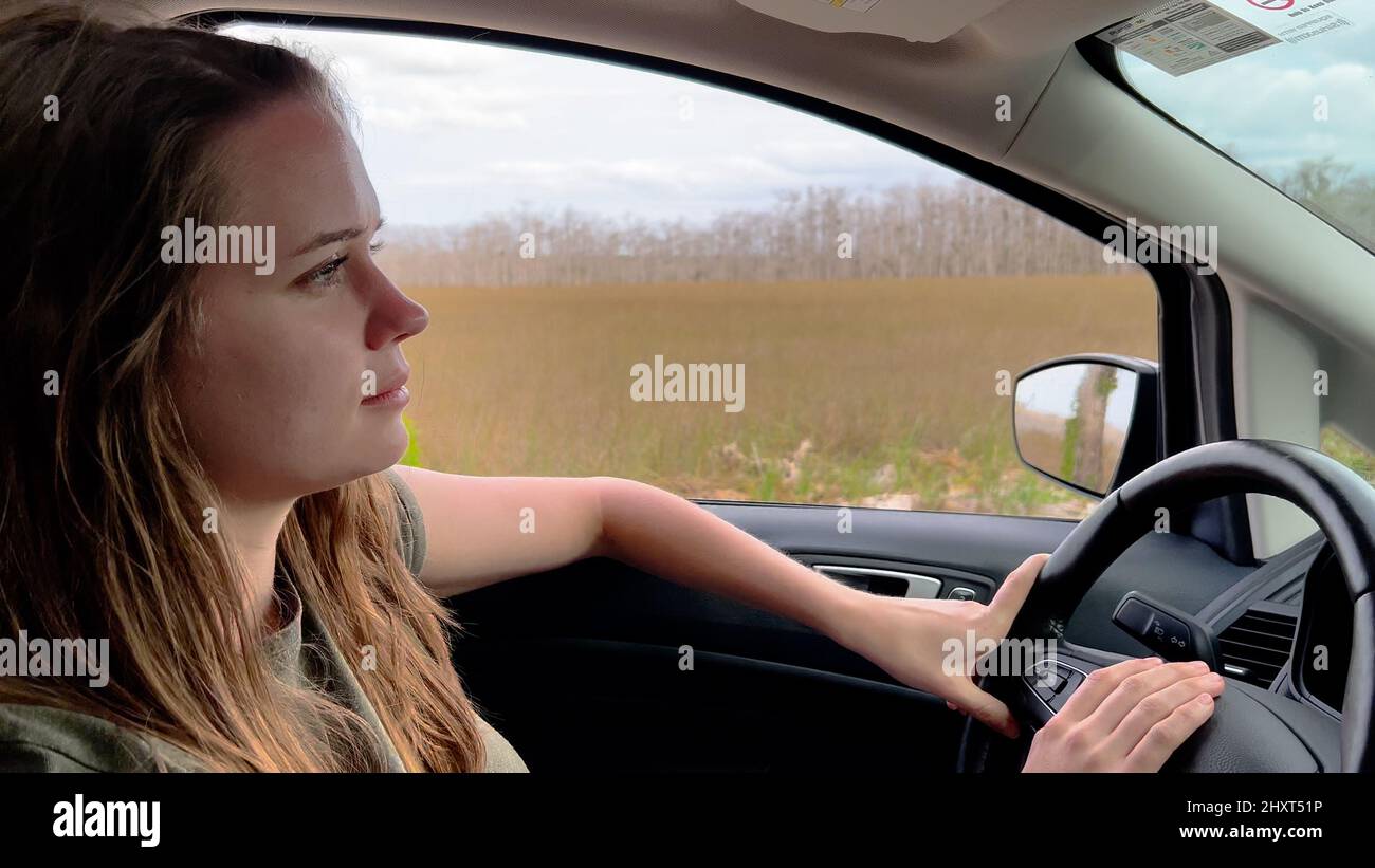 Young woman driving a car - close up shot Stock Photo - Alamy