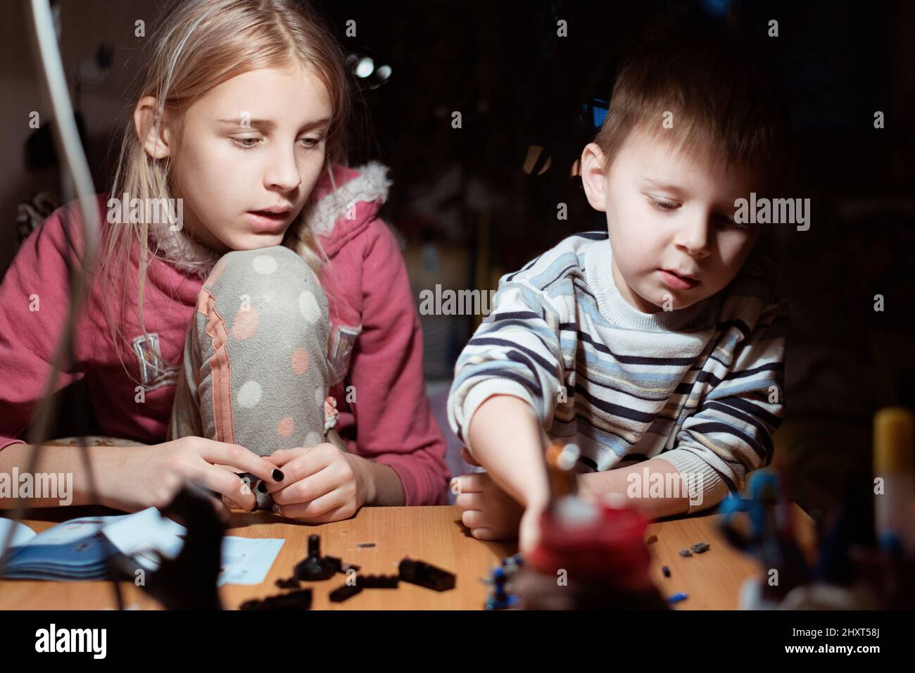 Two children, the elder sister and the younger brother are engaged together. Family ...