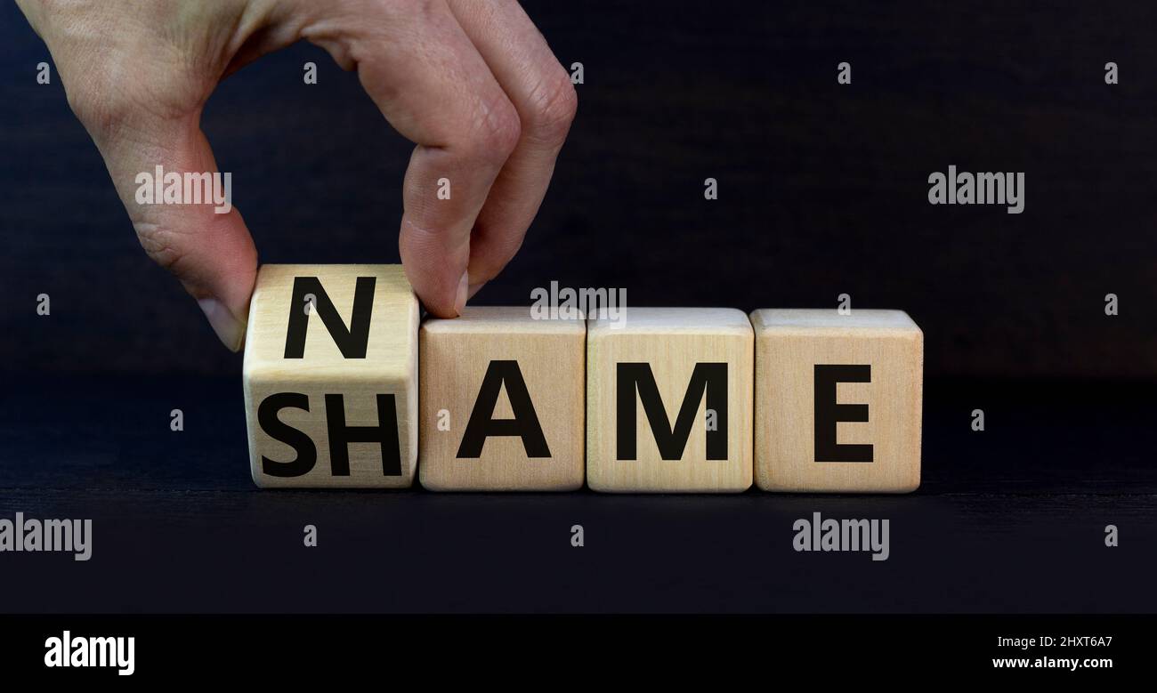 Name or shame symbol. Businessman turns the wooden cube and changes the ...