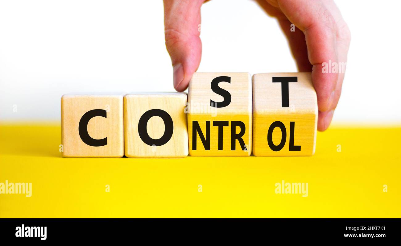 Cost control symbol. Businessman turns wooden cubes and changes the ...