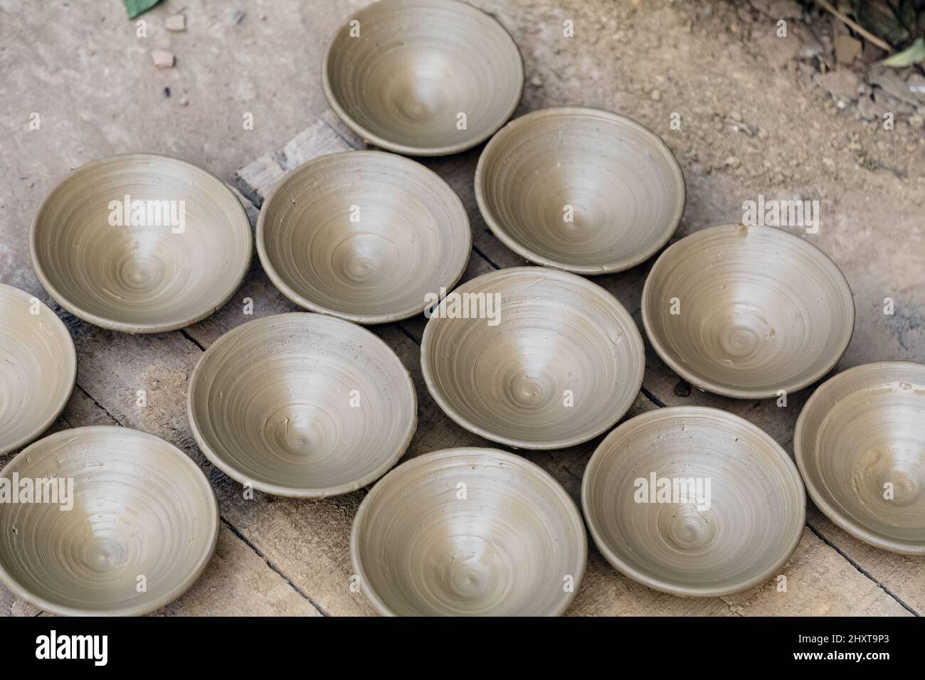 Closeup of many earthen pots or clay pots drying in the sun in the ...