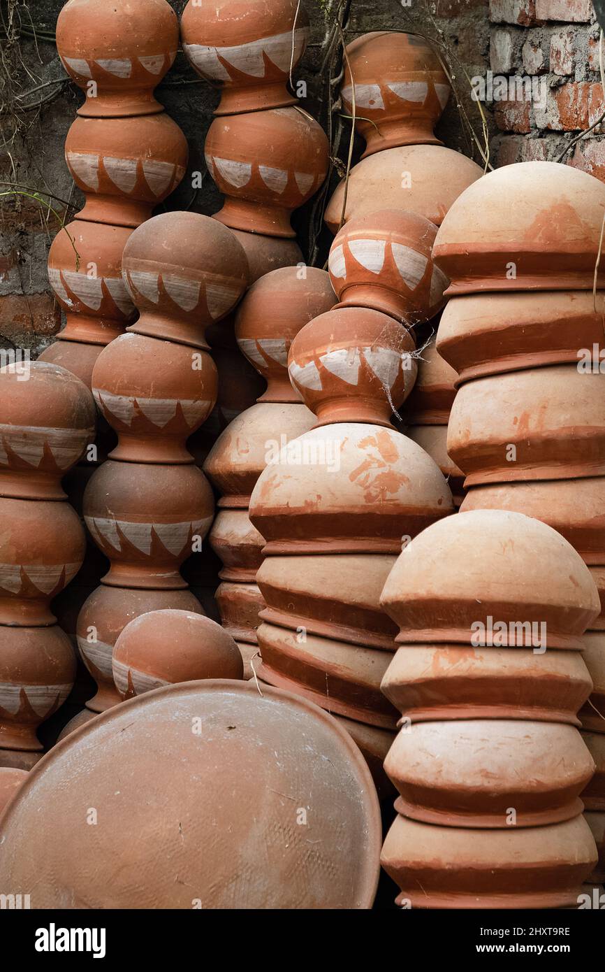 Closeup of many earthen pots or clay pots drying in the sun in the ...
